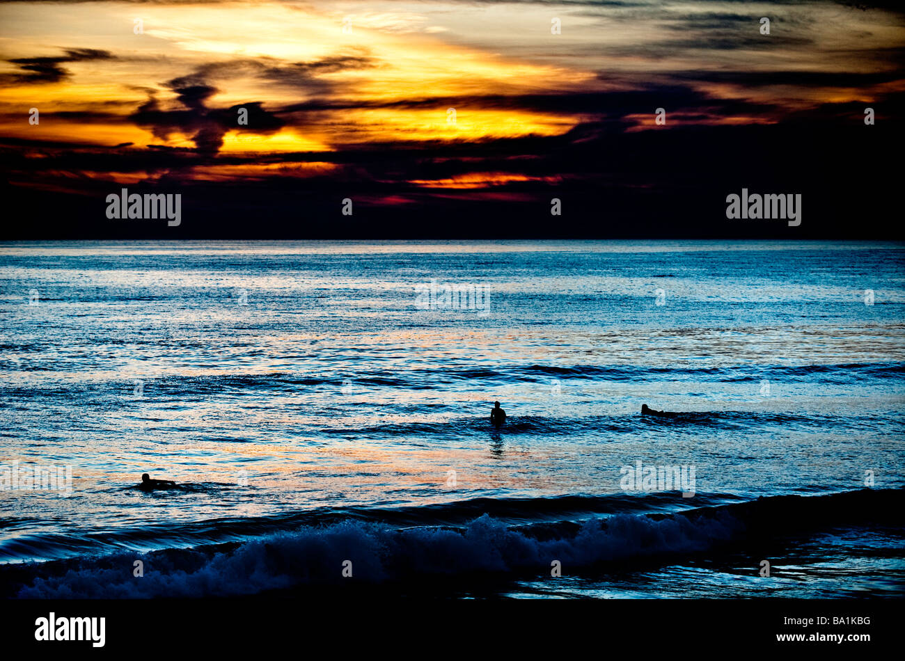 surfing at sunset Stock Photo - Alamy