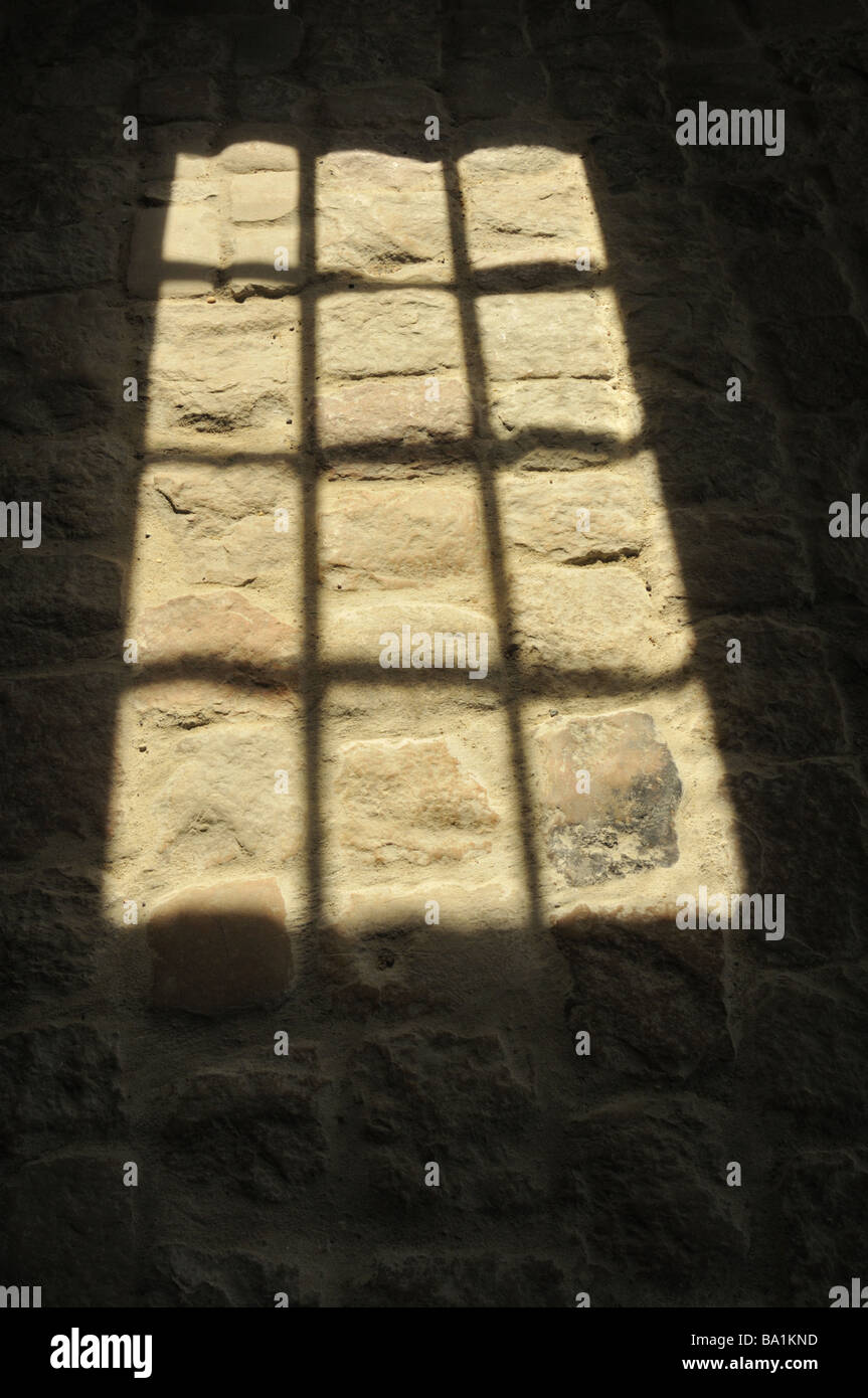 Lights through a window falling on cobblestoned floor Stock Photo - Alamy
