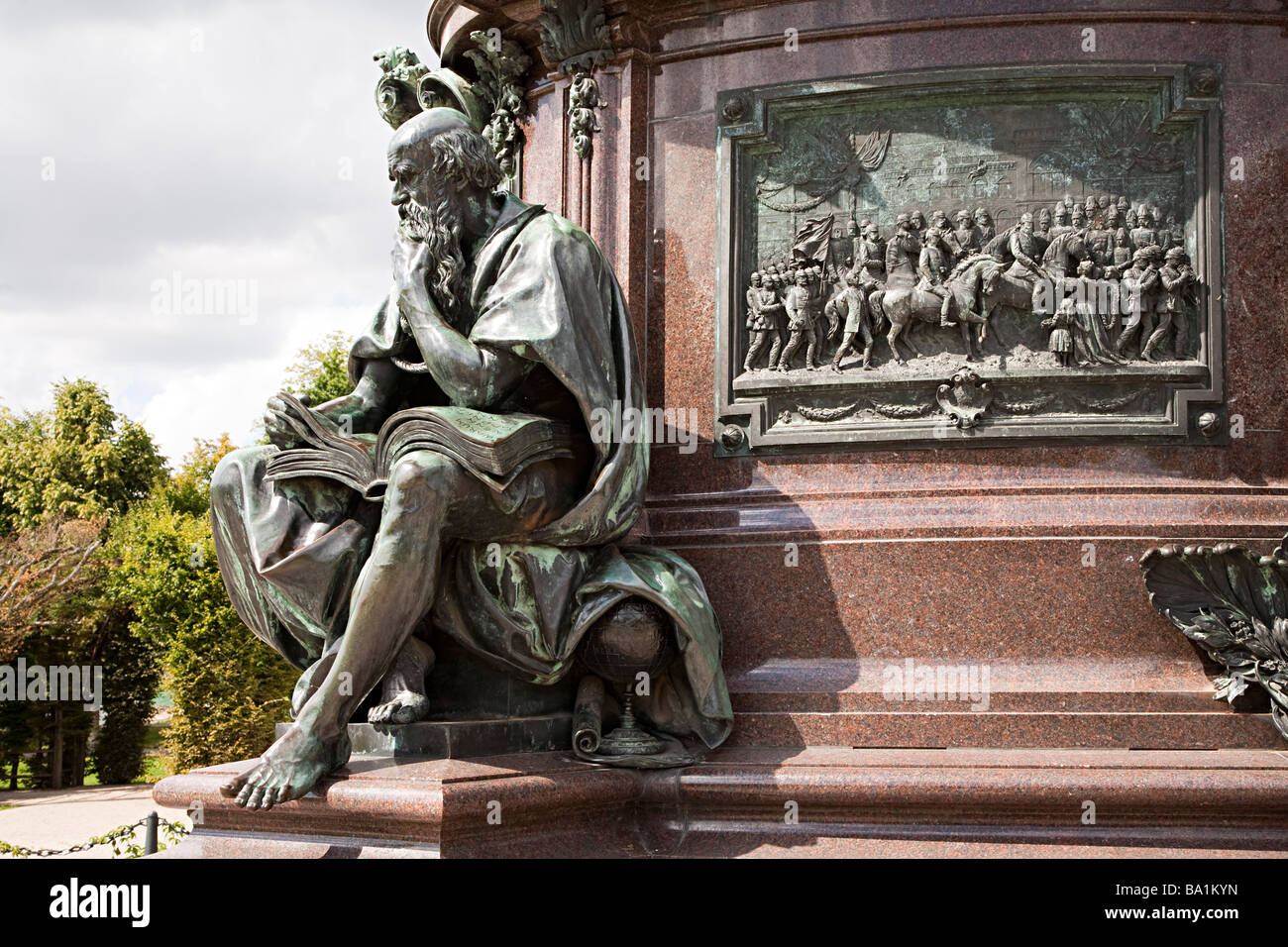 Bronze statue of philosopher with frieze of triumphant procession ...