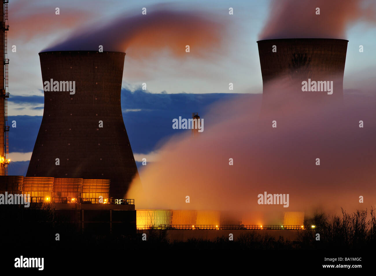 Steam billows from cooling towers at the petrochemical refinery in ...