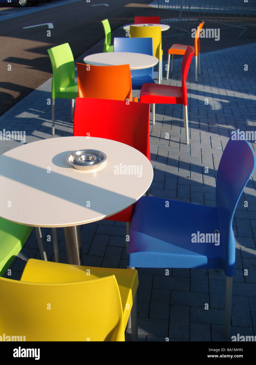 coloured chairs outside restaurant Stock Photo - Alamy