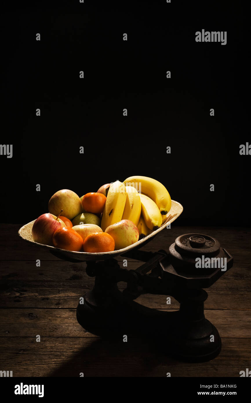 Mixed fruit on vintage scales Stock Photo - Alamy