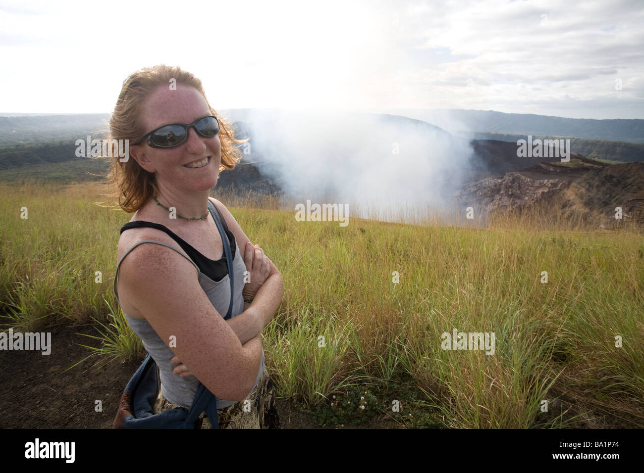 Woman in front of active volcano Stock Photo - Alamy