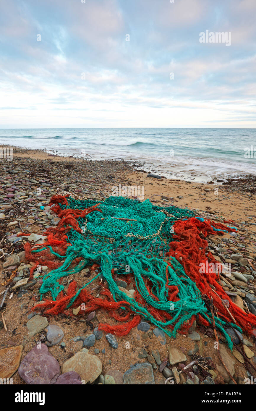 fishing nets,stones and debris, washed ashore on beach in Co.Cork ...