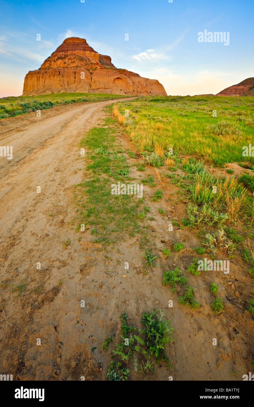 Road leading to Castle Butte during sunset in the Big Muddy Badlands ...