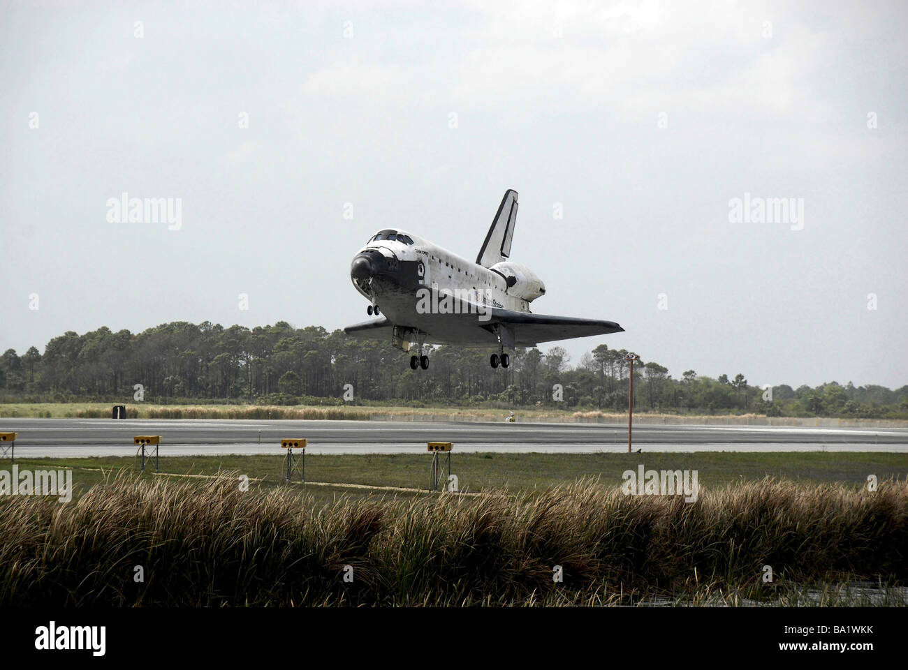 Space Shuttle Discovery approaches landing on the runway at the Kennedy ...