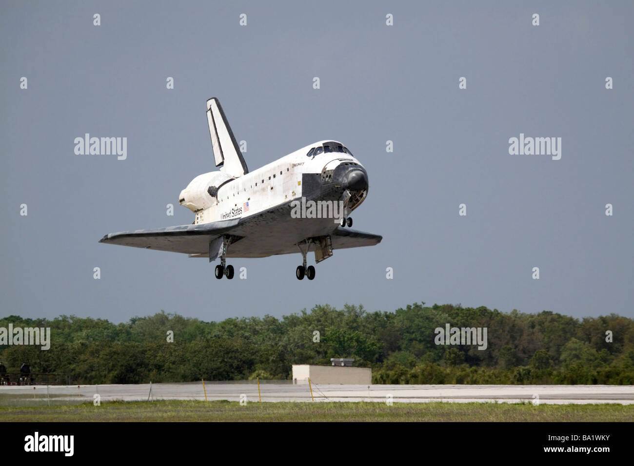 Space Shuttle Discovery approaches landing on the runway at the Kennedy ...