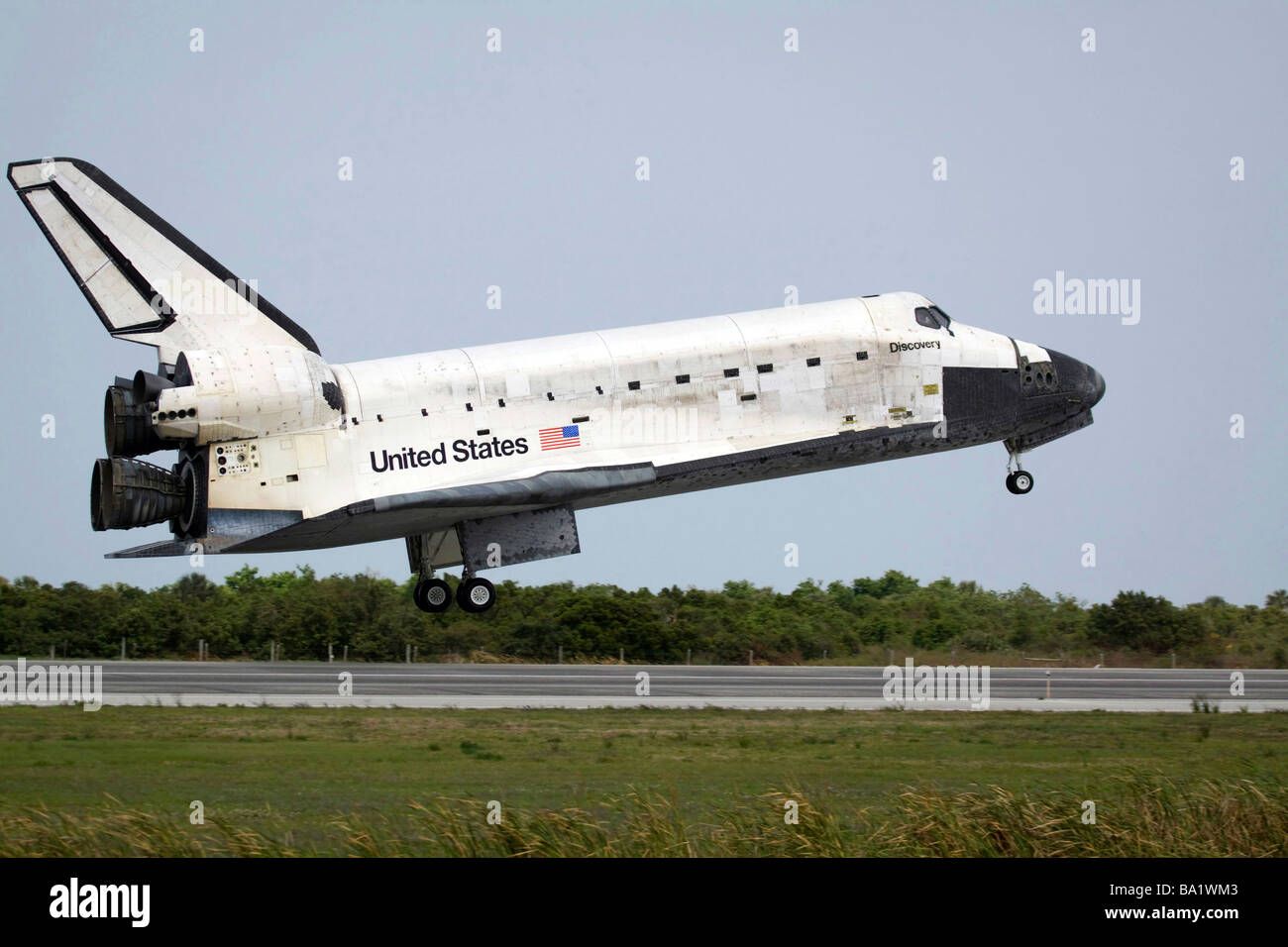 Space Shuttle Discovery approaches landing on the runway at the Kennedy ...
