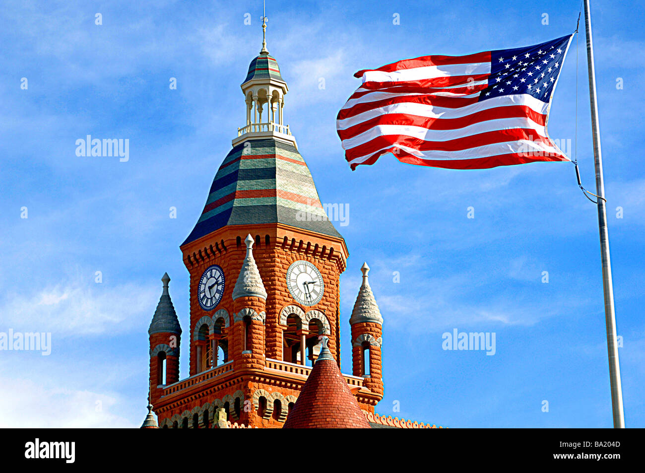US flag flies high above an old style courthouse in downtown Dallas ...