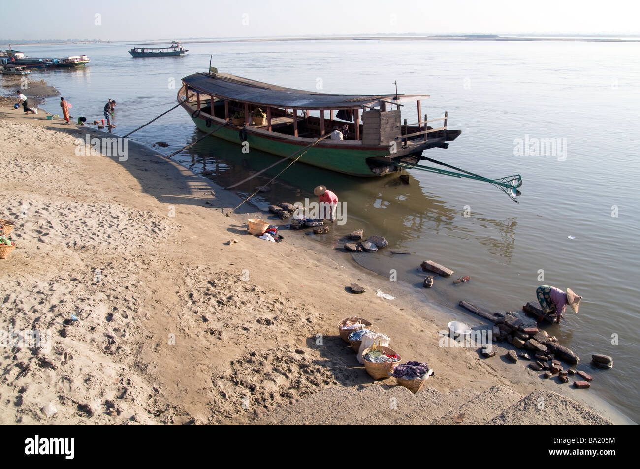 MYANMAR/BURMA. WASHING CLOTHES ON THE IRRAWADY RIVER IN KATHA WHERE ...