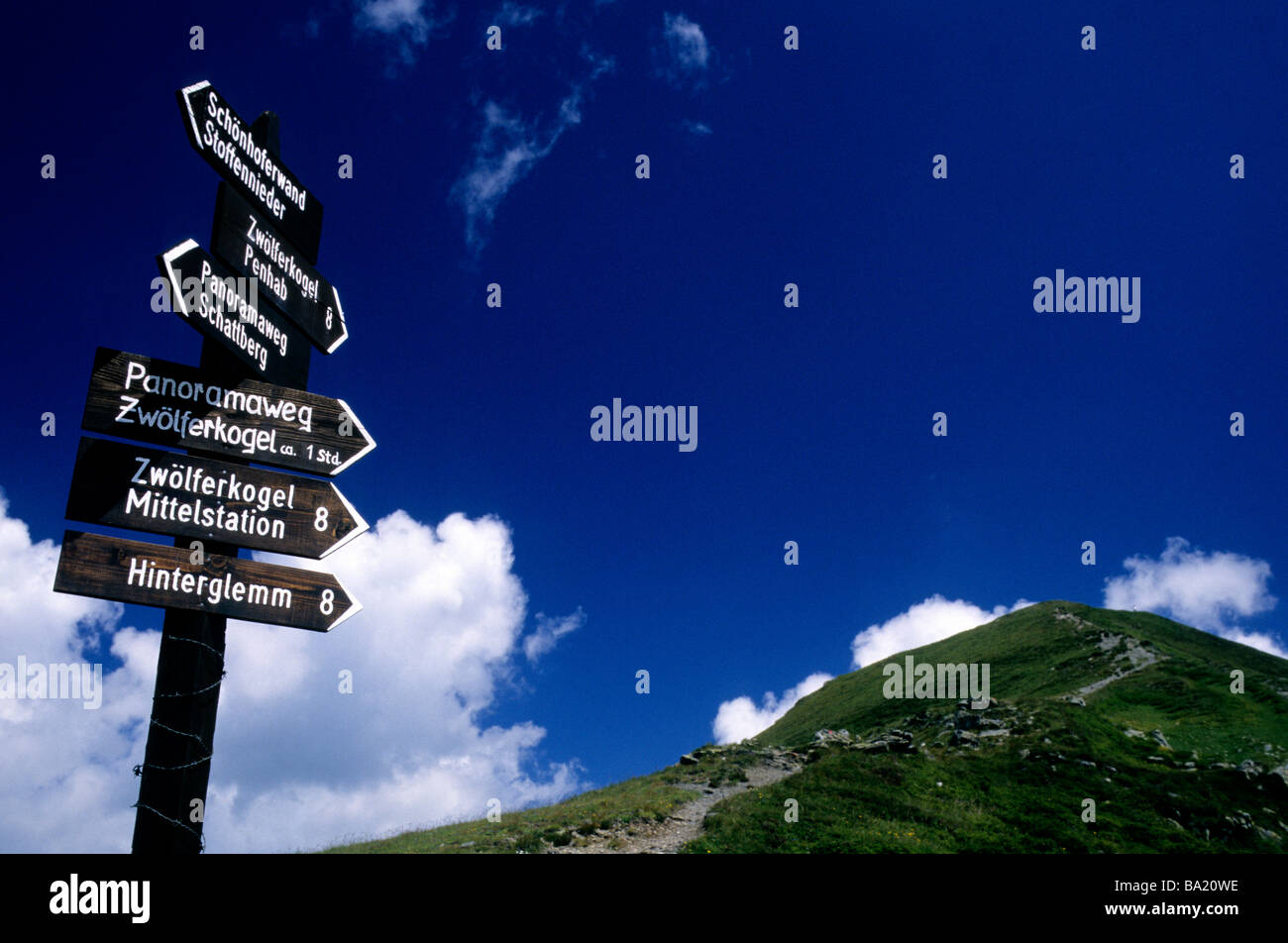 A hiking trail direction sign situated at the beginning of a path that ...