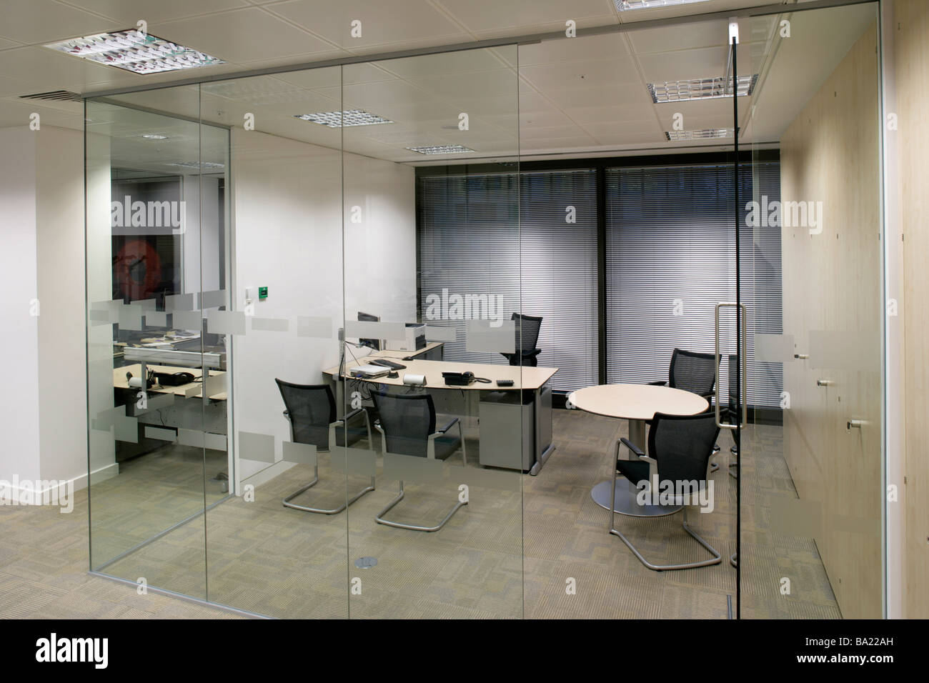 Executive office through glass partition Stock Photo - Alamy