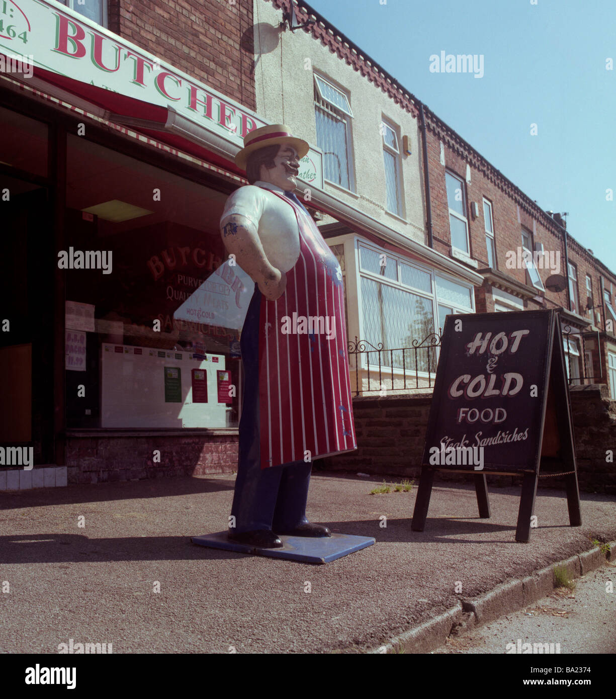Butcher's shop front with statue of a happy butcher Stock Photo - Alamy