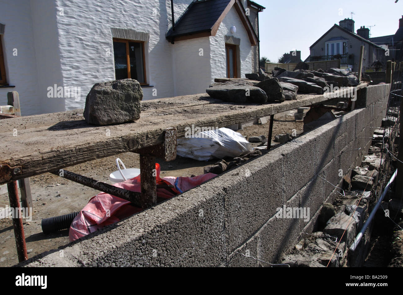 New home, stone wall being built Stock Photo - Alamy