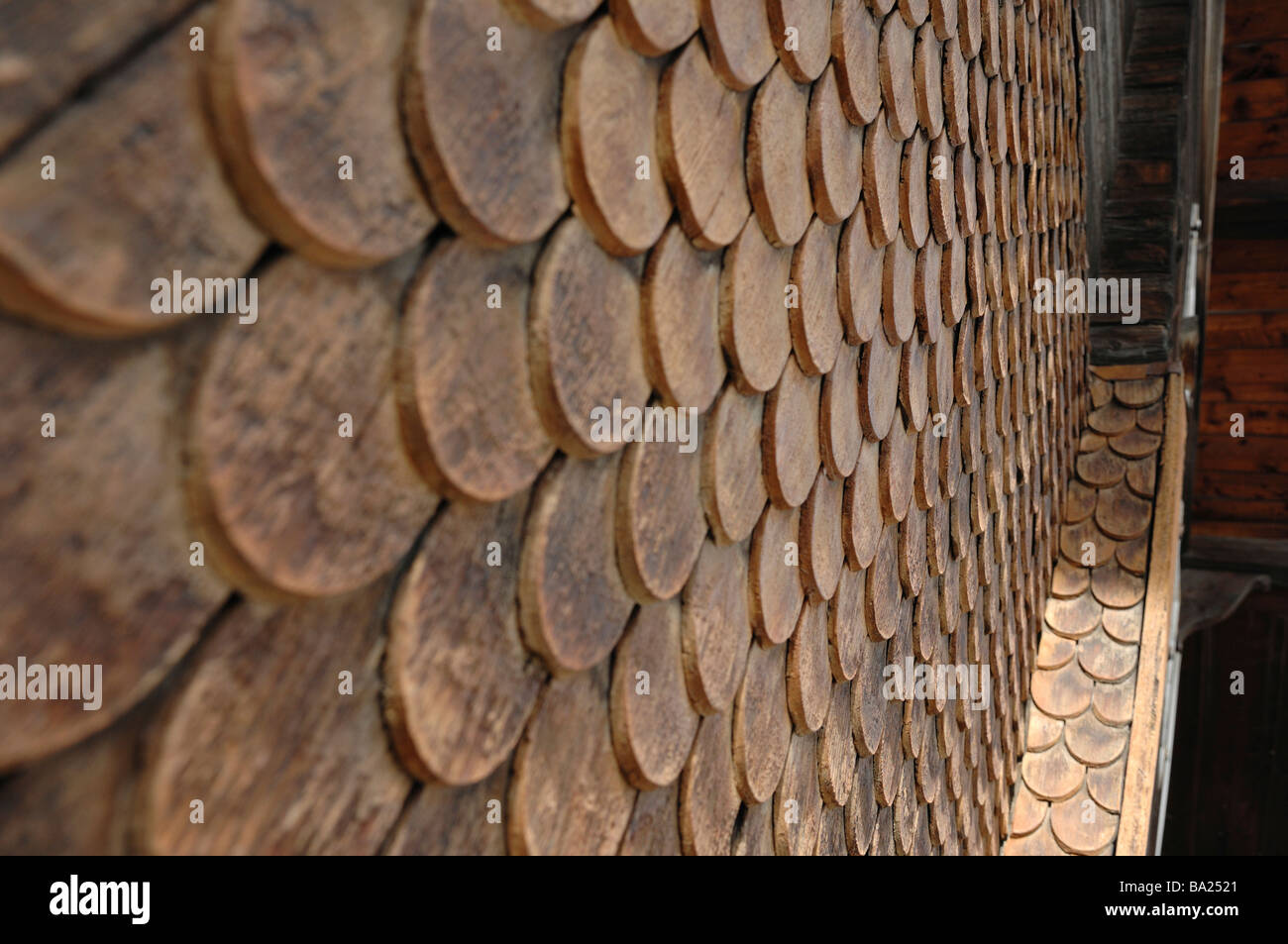 The perspective of wooden tiles on the wall of a mountain chalet in the ...