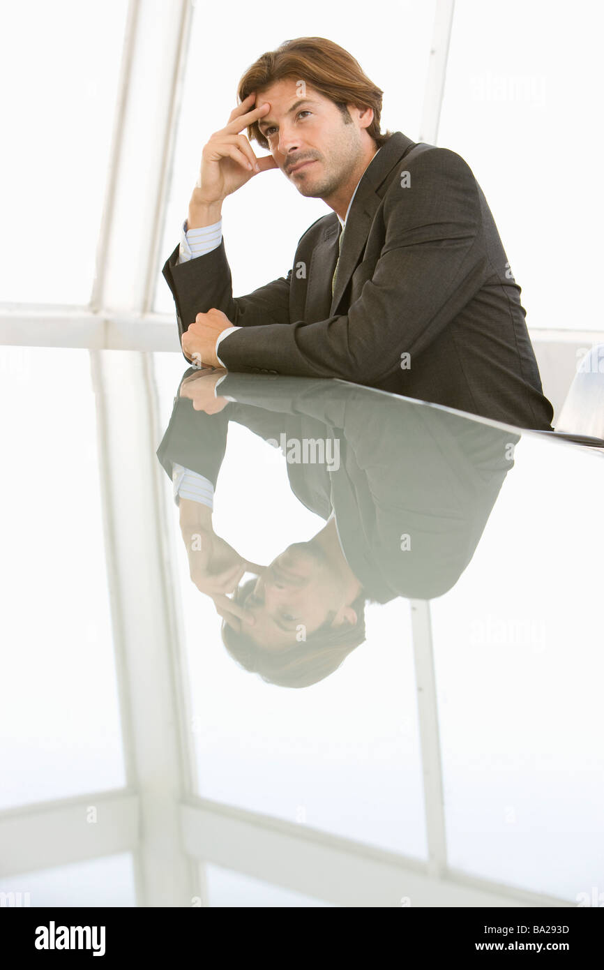Business man sitting at conference table Stock Photo - Alamy