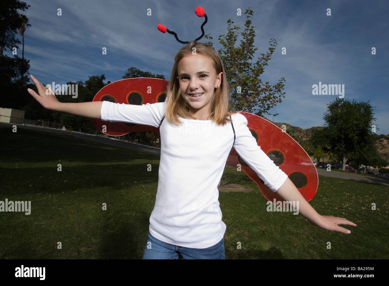 Portrait of girl (10-12) wearing ladybug costume Stock Photo - Alamy