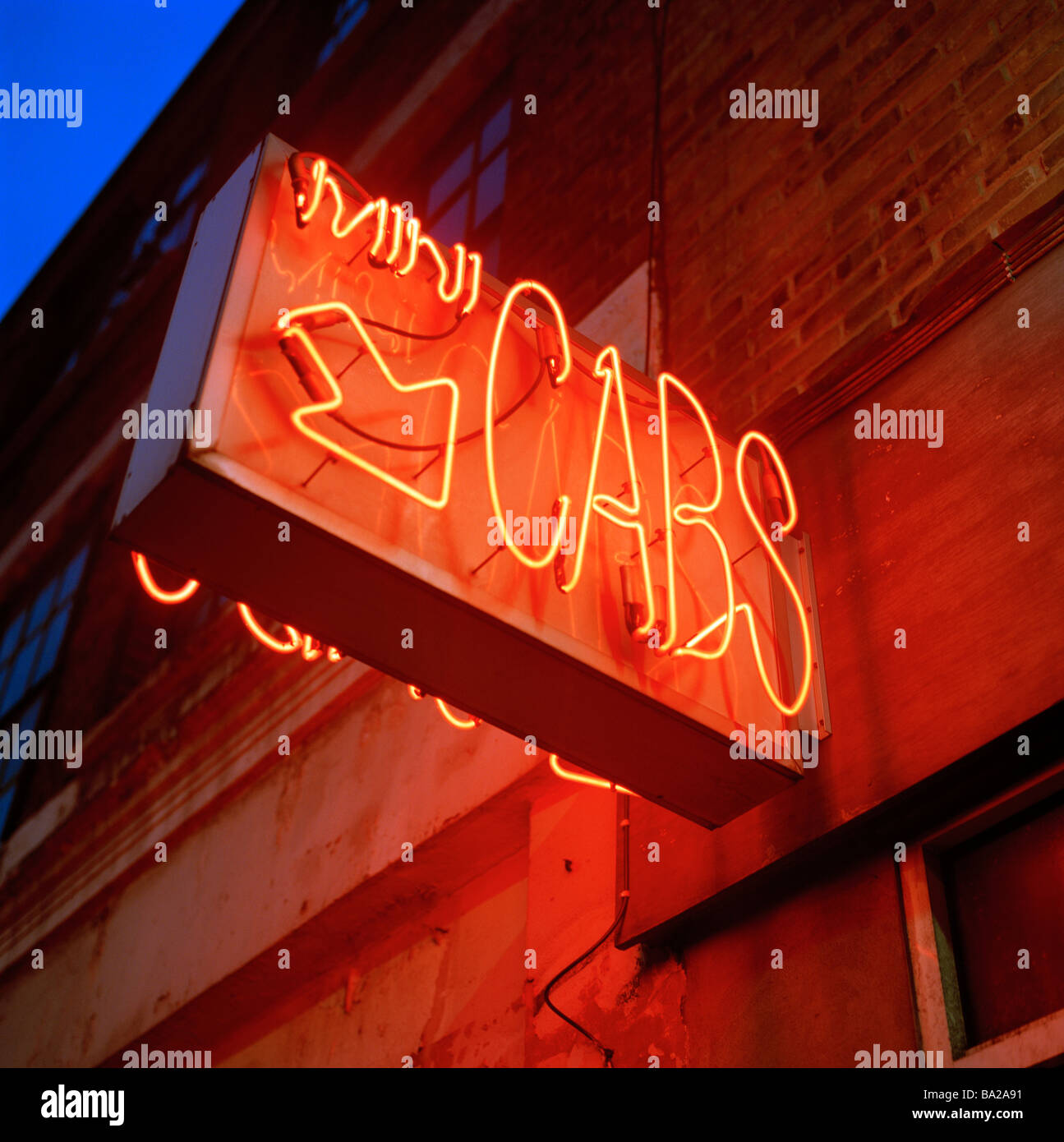 Neon sign for a mini cab office in Hoxton, London Stock Photo - Alamy