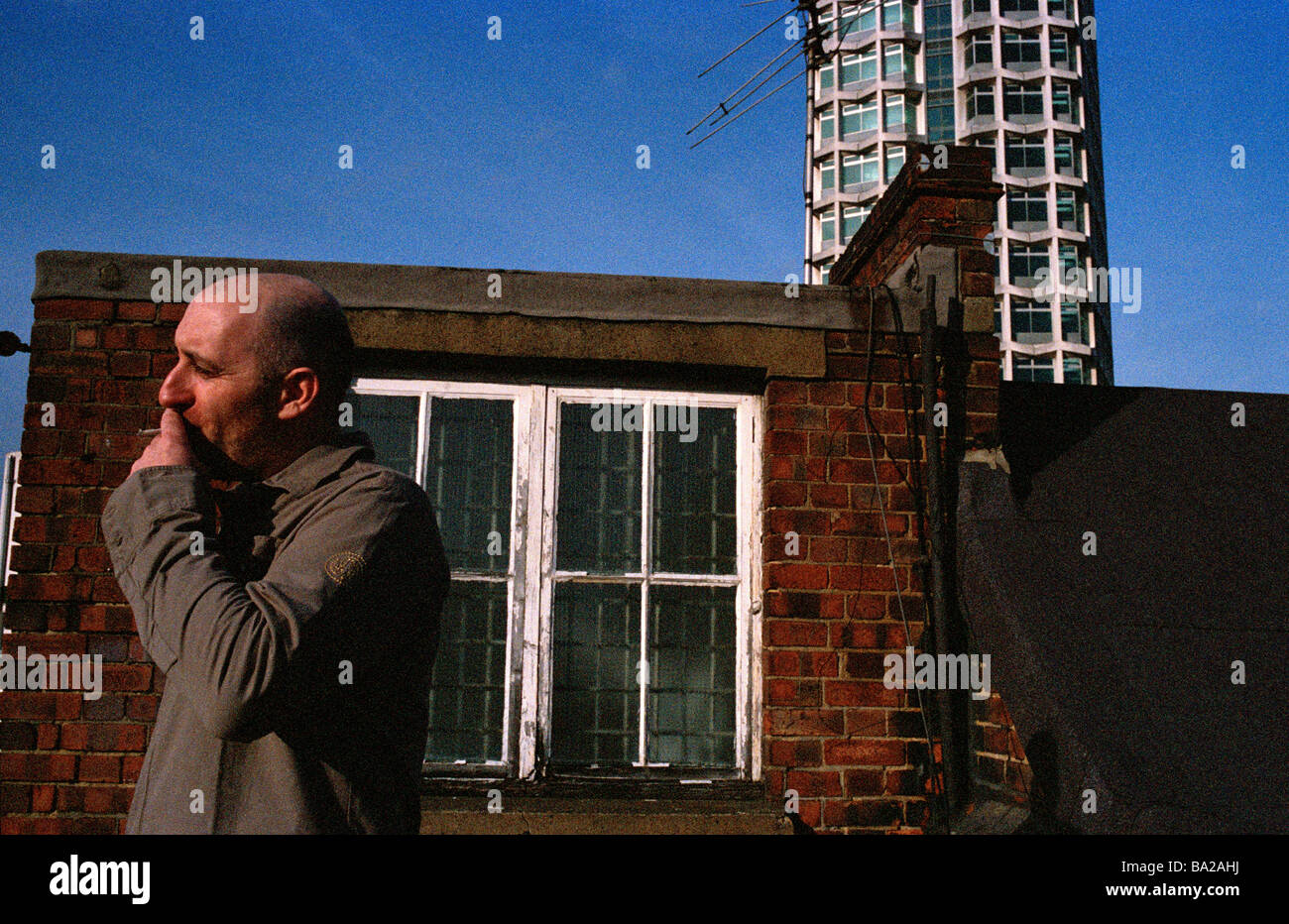 Man having a cigarette break outside his office in Soho, London Stock ...