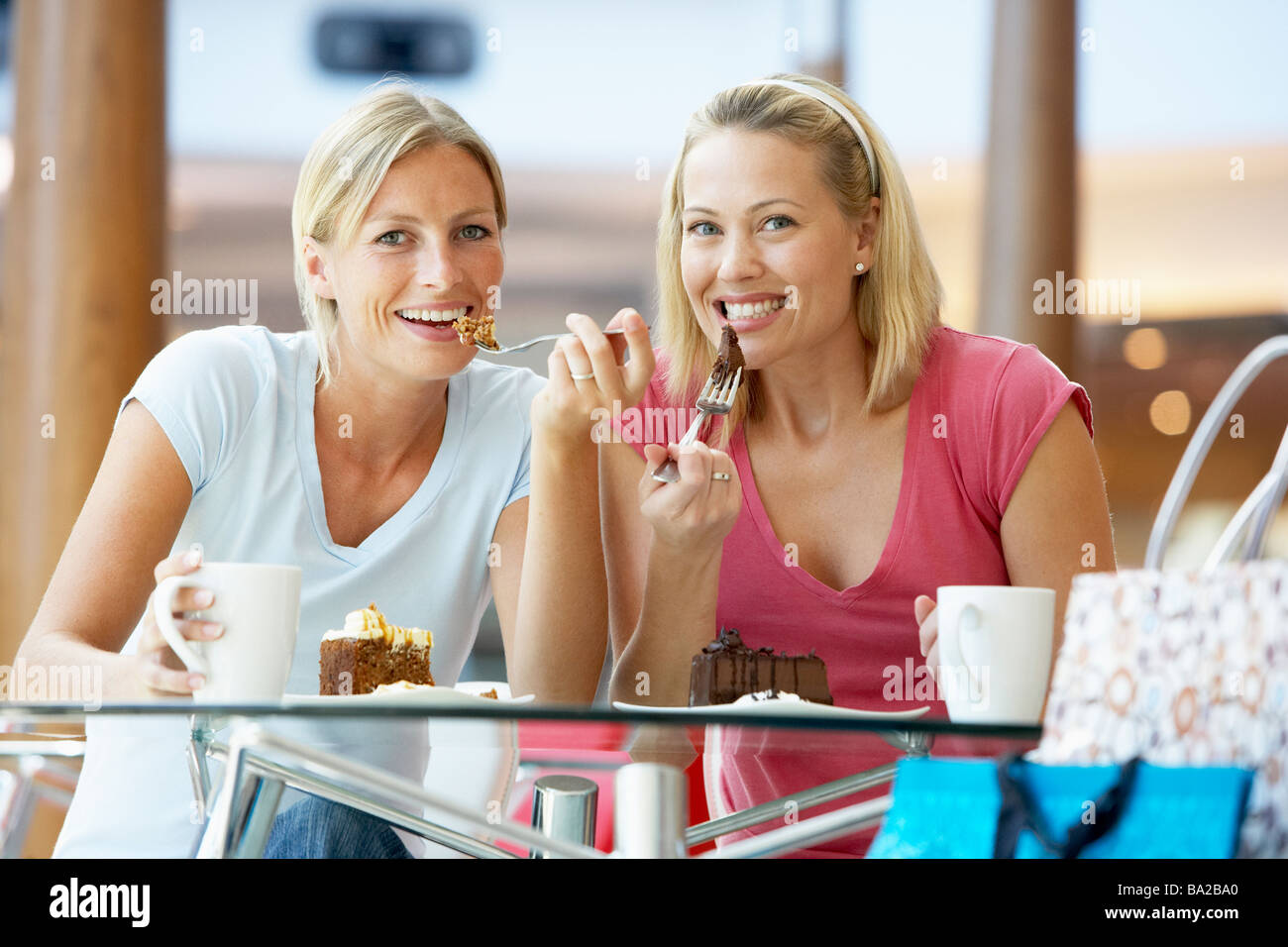 Female Friends Having Lunch Together At The Mall Stock Photo - Alamy