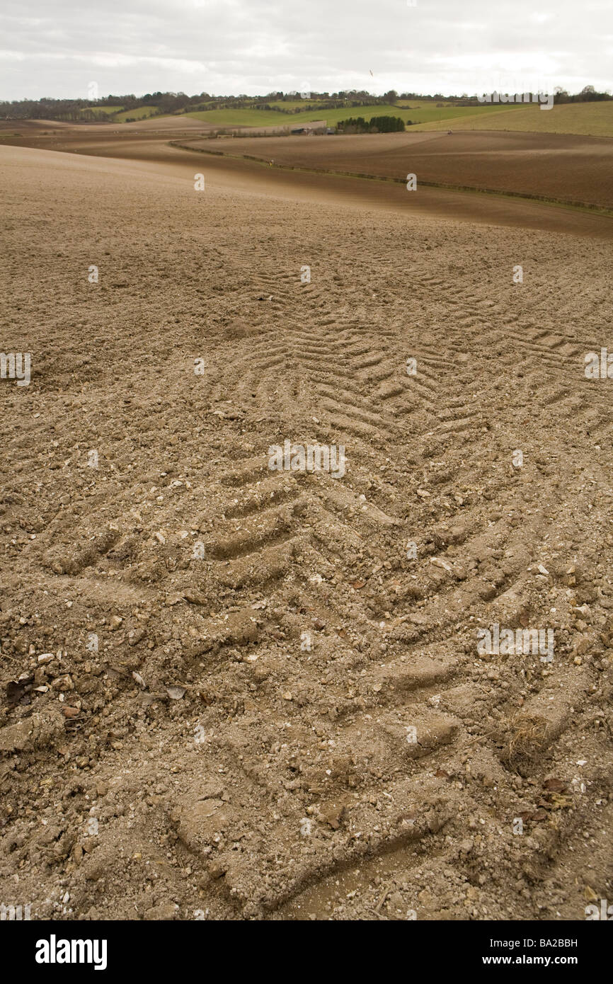 tractor marks in the dirt of a ploughed field on a farm in the ...