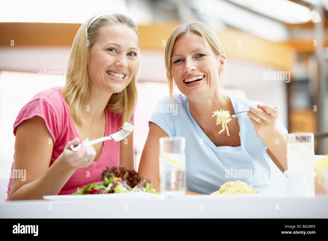 Female Friends Having Lunch Together At The Mall Stock Photo - Alamy