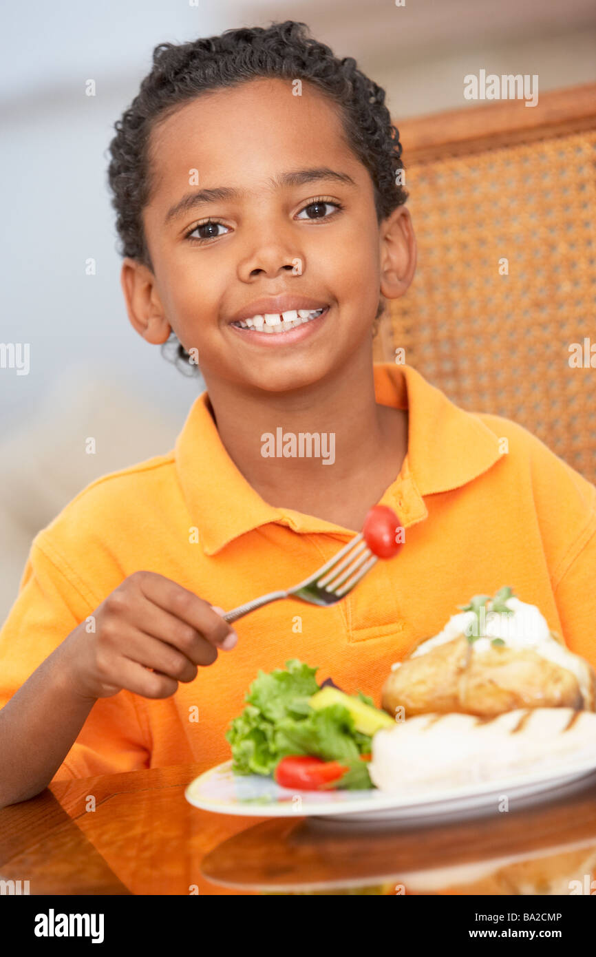 Young Boy Enjoying A Meal At Home Stock Photo - Alamy