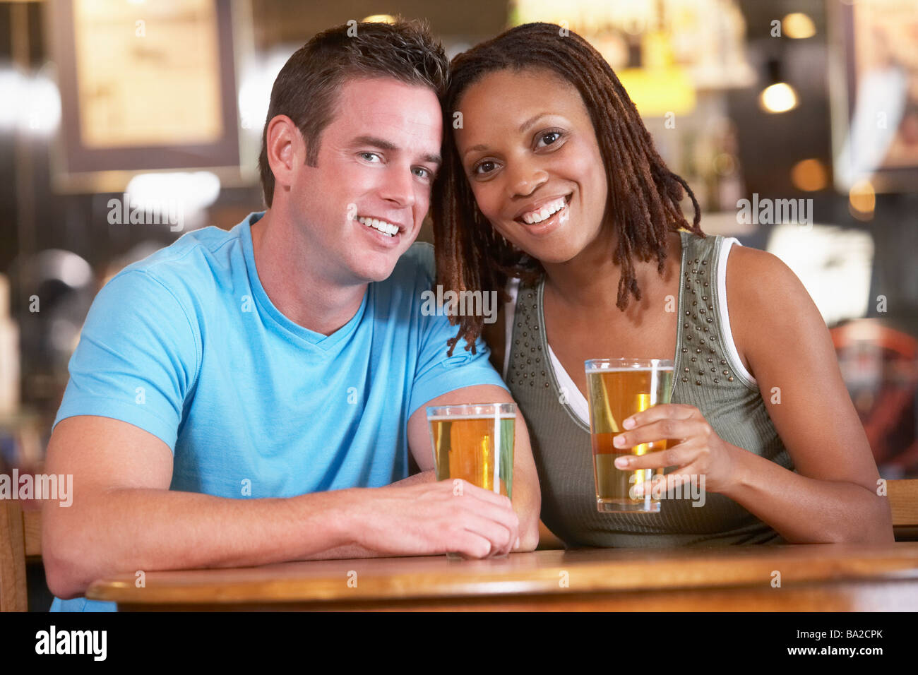 Couple Drinking Beer Together In A Pub Stock Photo - Alamy