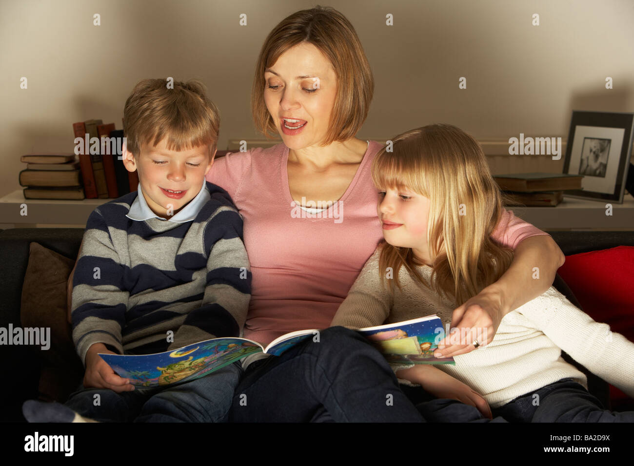 Mother And Children Reading Stock Photo - Alamy