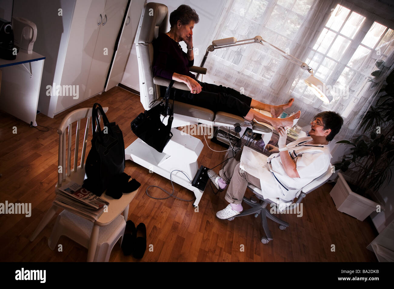 Chiropodist during treatment in private clinic Stock Photo - Alamy