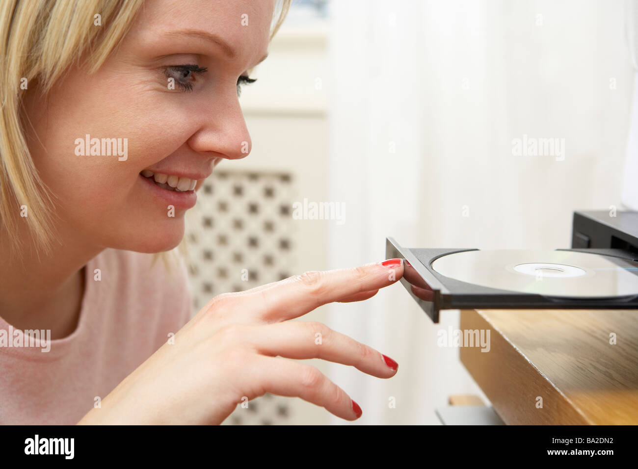 Young Woman Closing DVD Player With Finger Stock Photo - Alamy
