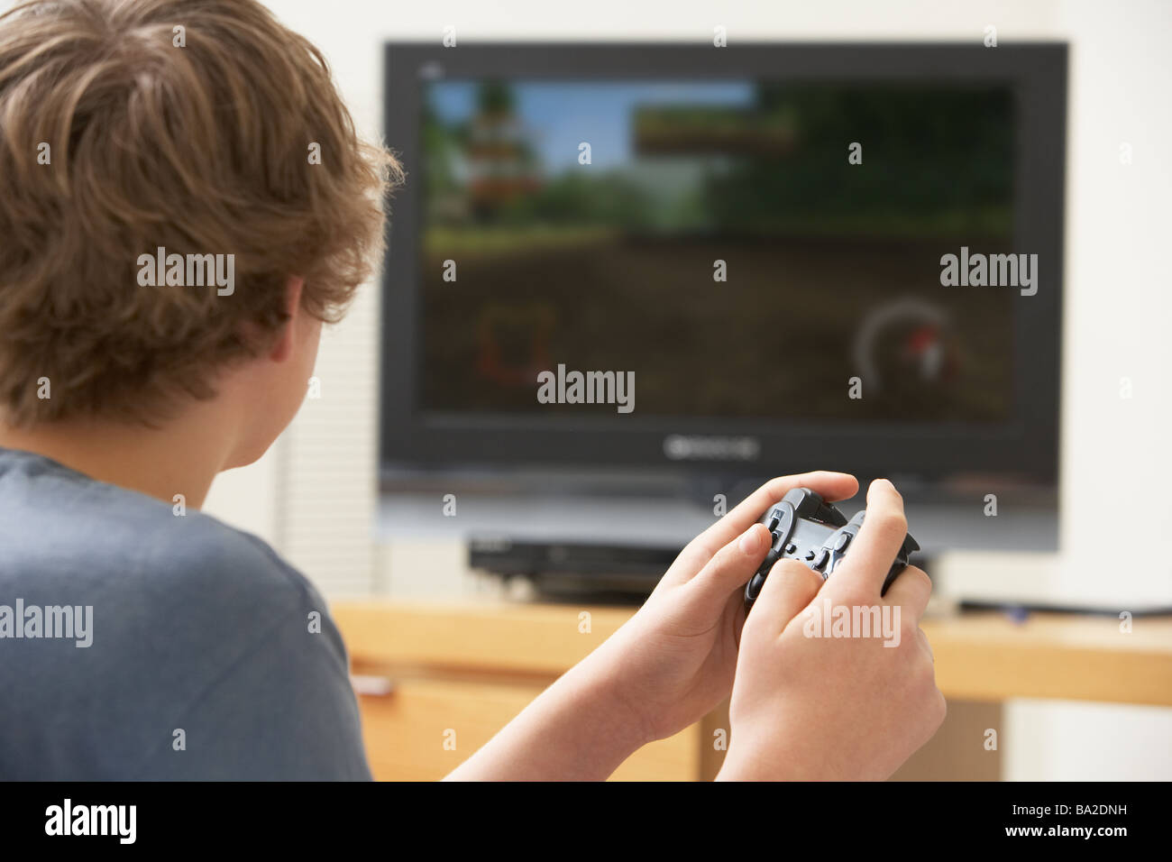 Teenage Boy Playing With Game Console Stock Photo - Alamy