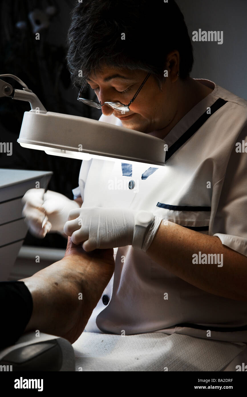 Chiropodist during treatment in private clinic Stock Photo - Alamy