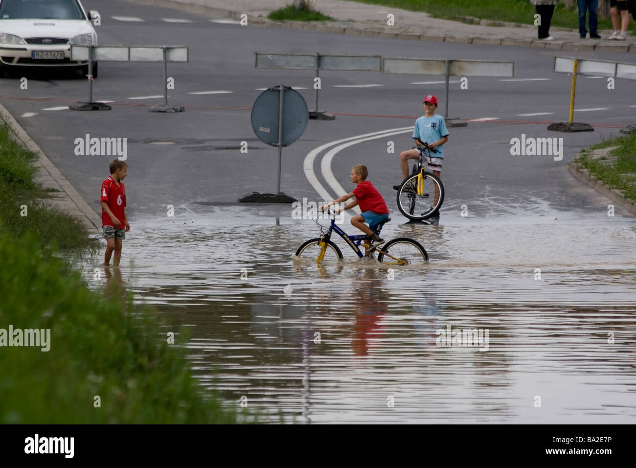 Children playing in flooded street hi-res stock photography and images ...