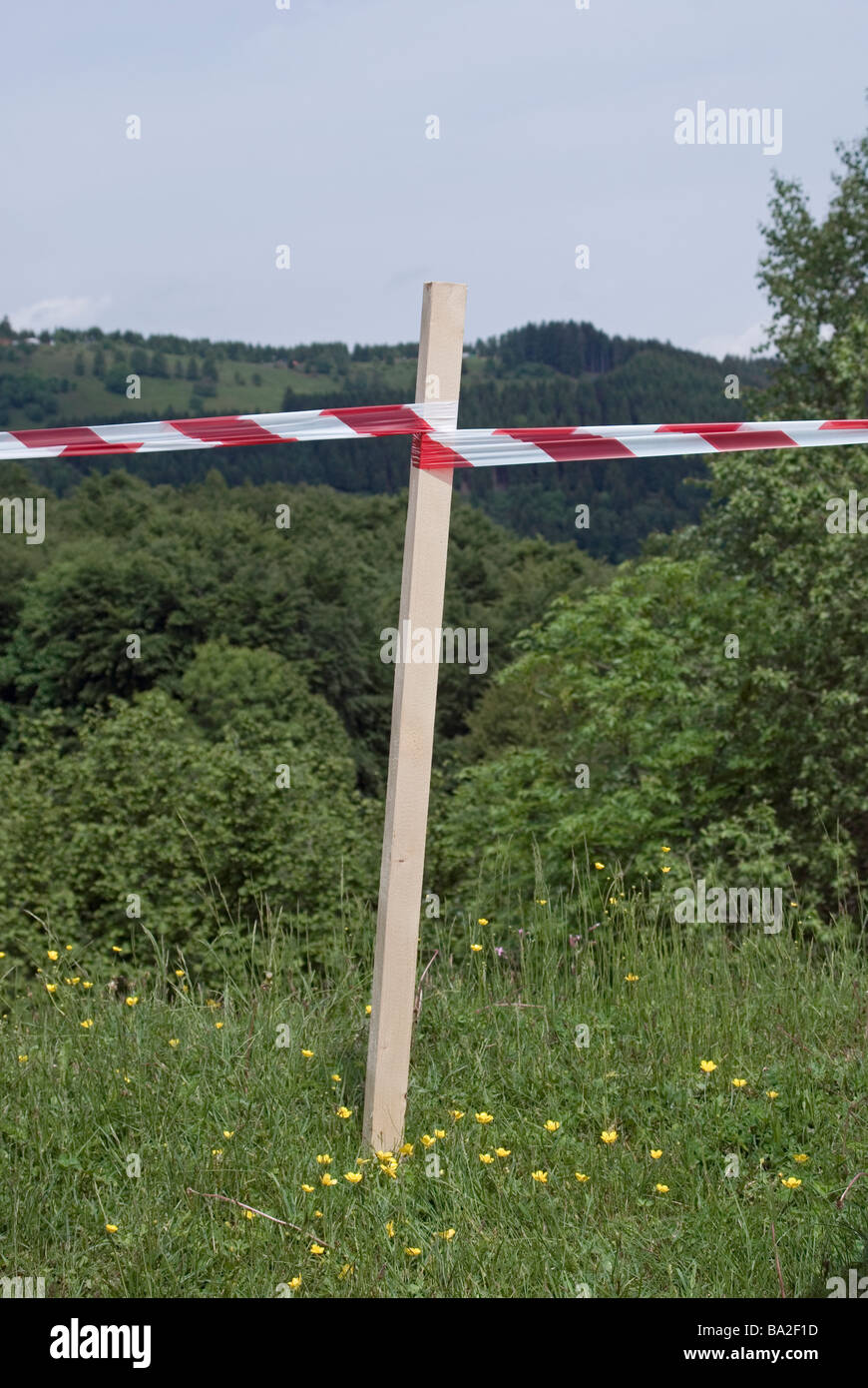 Red and white barrier tape preventing access and wooden post Stock ...