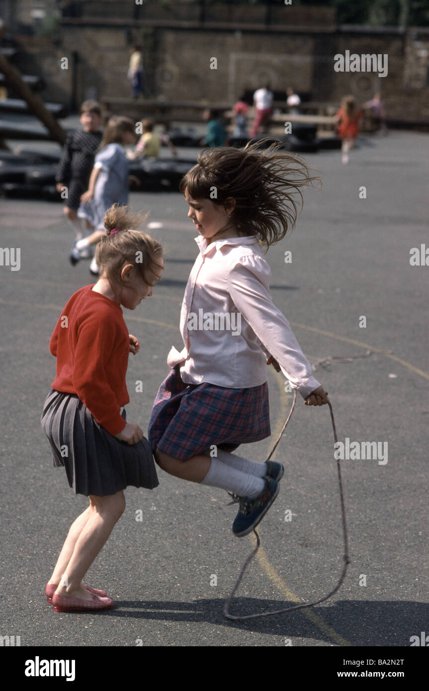 primary school girls skipping together in school playground Stock Photo ...