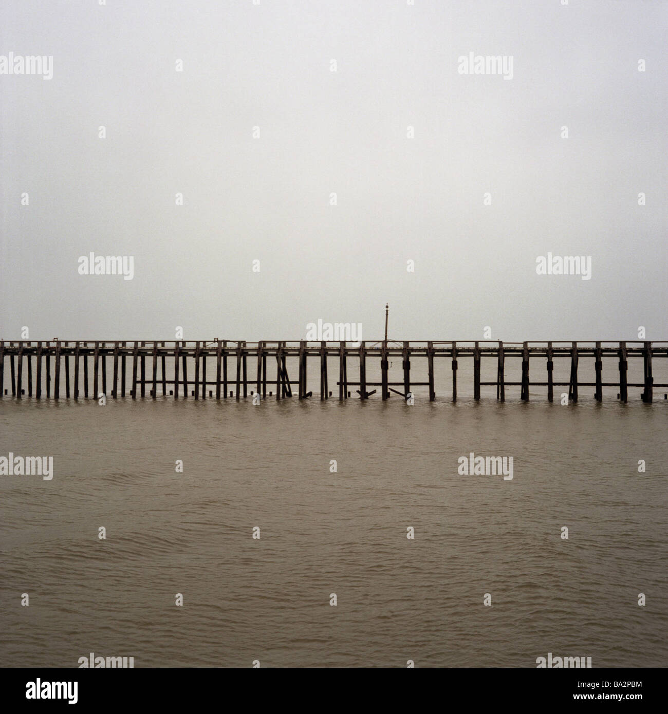 Sea wood-bridge dully water bridge pier wood-posts heavens clouds ...