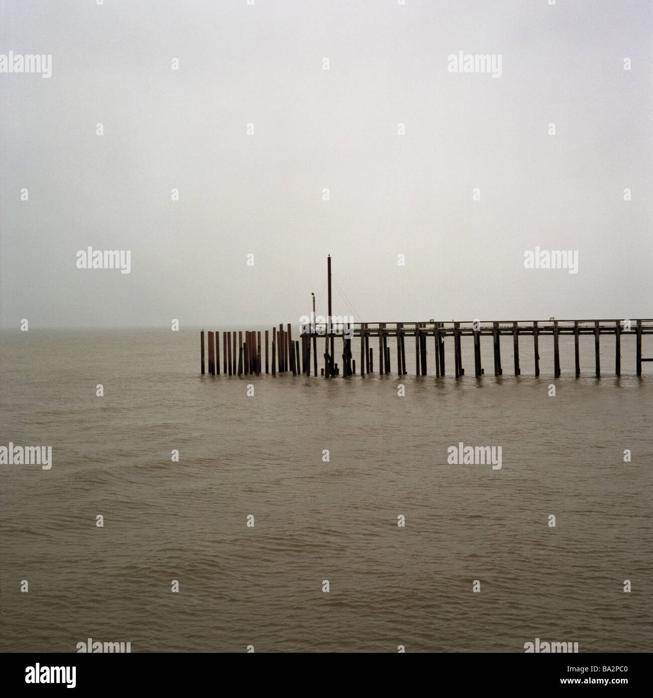 Sea wood-bridge dully water bridge pier wood-posts heavens clouds ...