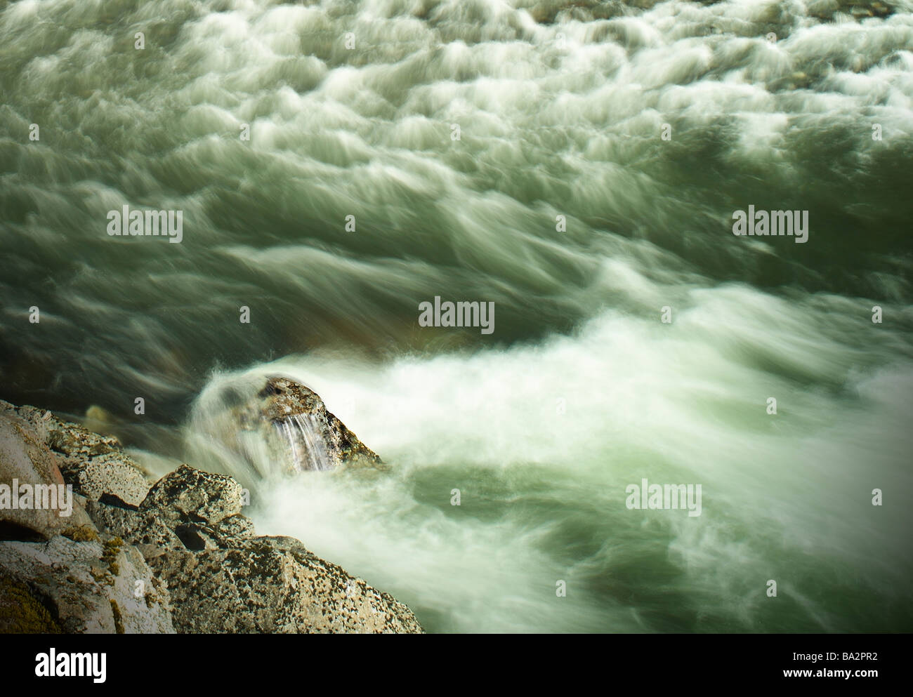 Rock in rushing river, New Zealand Stock Photo - Alamy