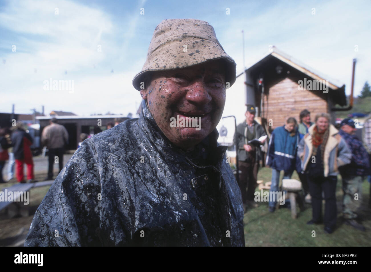 Senior rain-jacket hat filth wet portrait no models fisher face mud mud ...