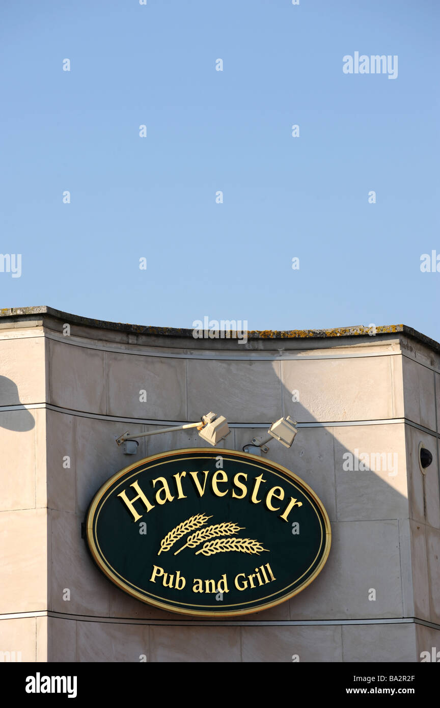 Harvester pub and grill sign against a blue sky Stock Photo - Alamy