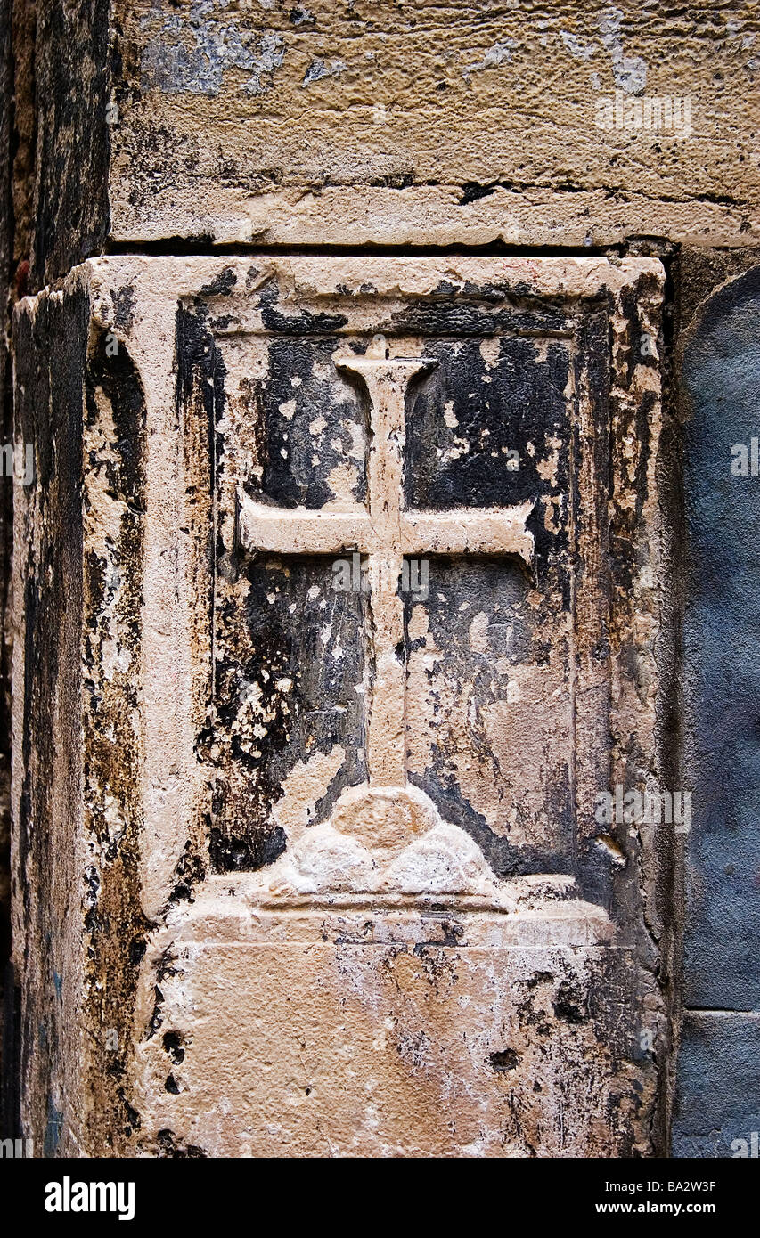 Ancient Masonic stone carving of a Catholic crucifix on the corner of a ...