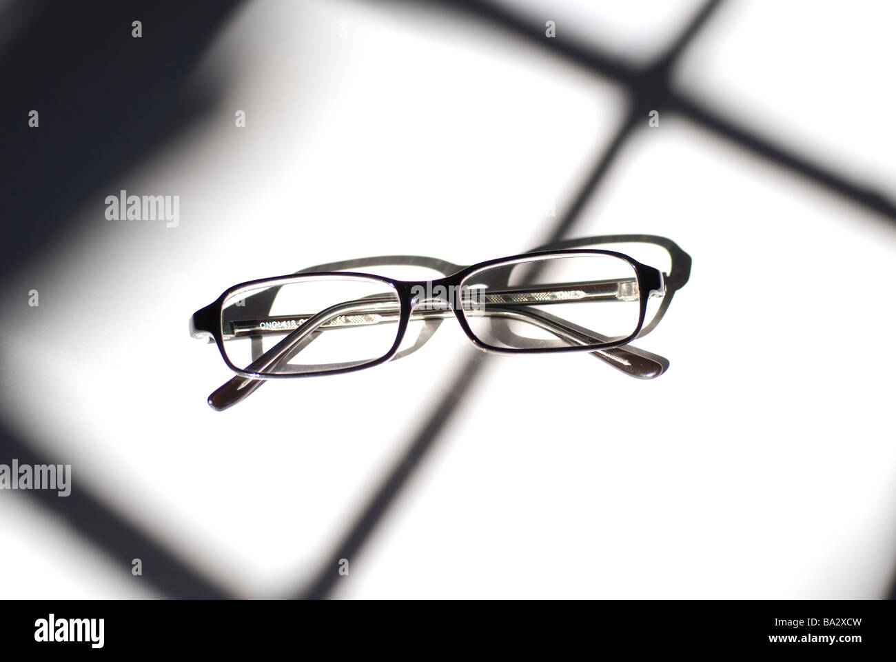 lens reading glasses under a window light reflexion Stock Photo - Alamy