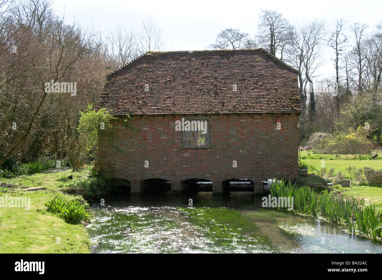 Seventeenth century restored building across a small stream near the ...