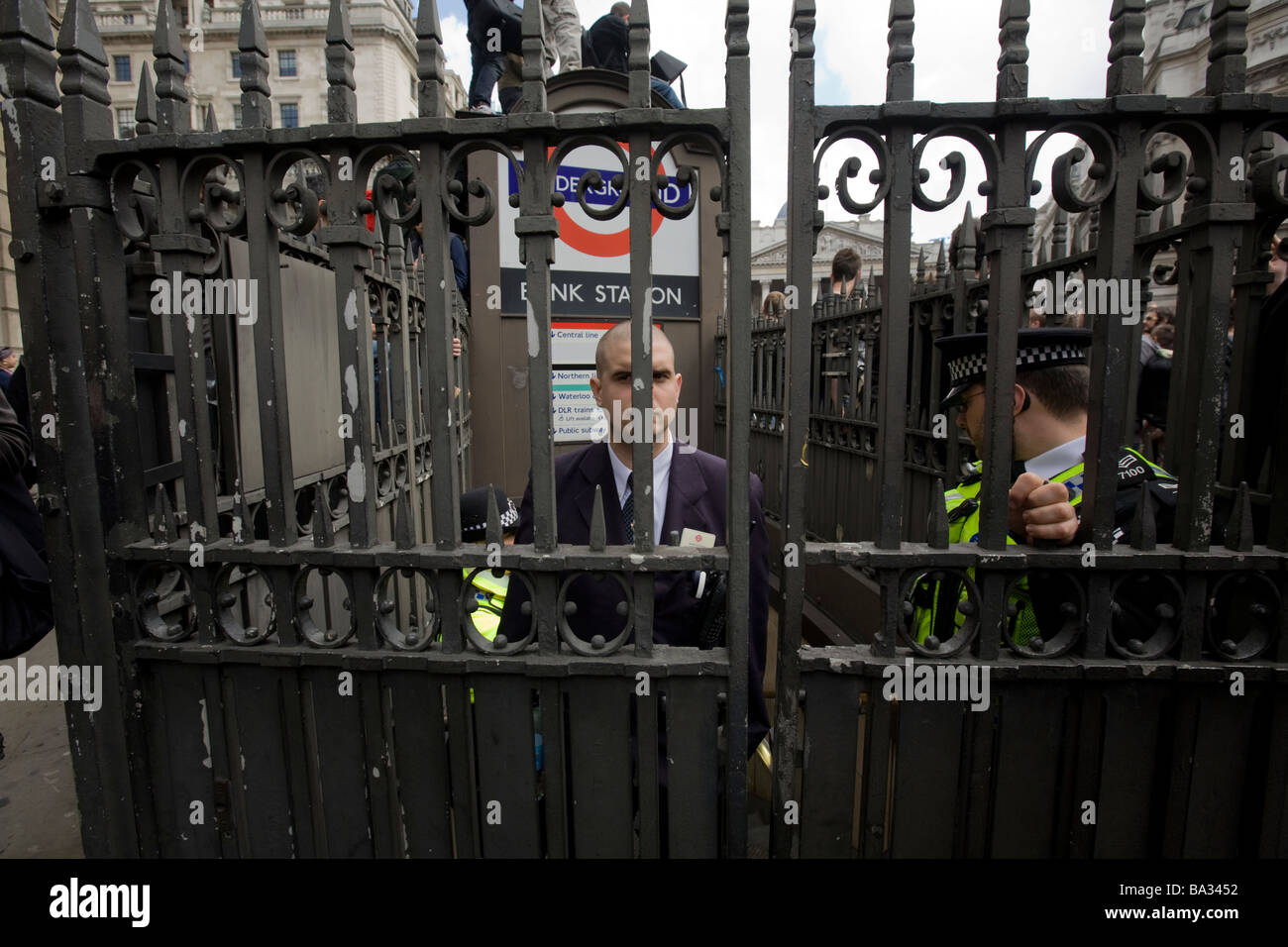 A Transport for London security official watches through the gated ...