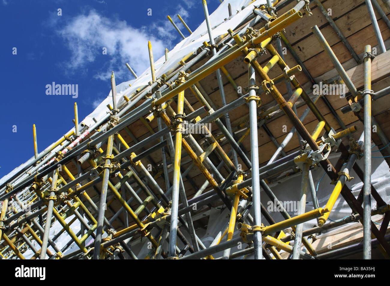 Scaffolding and blue sky from below Stock Photo - Alamy