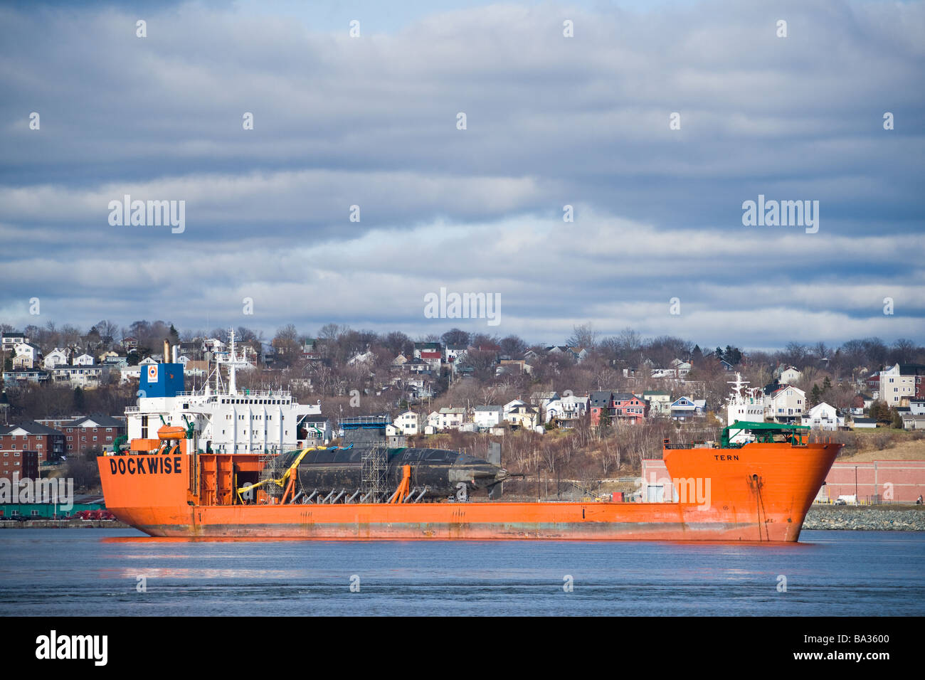 A semi-submersible ship embarks the submarine HMCS CHICOUTIMI in ...