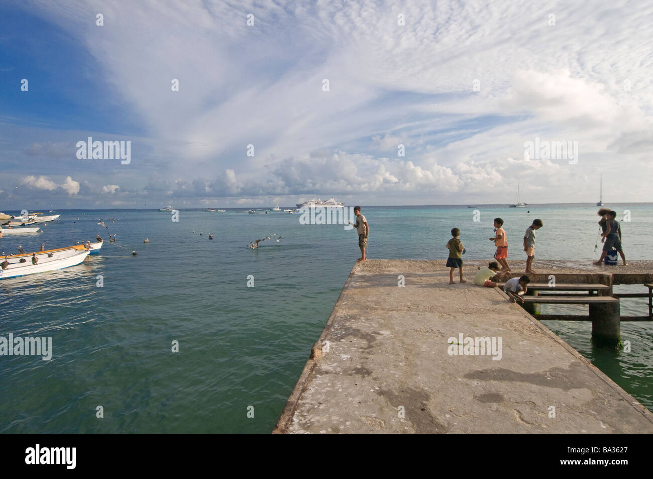 Children fishing off the pier in Grand Roque Los Roques Venezuela South ...