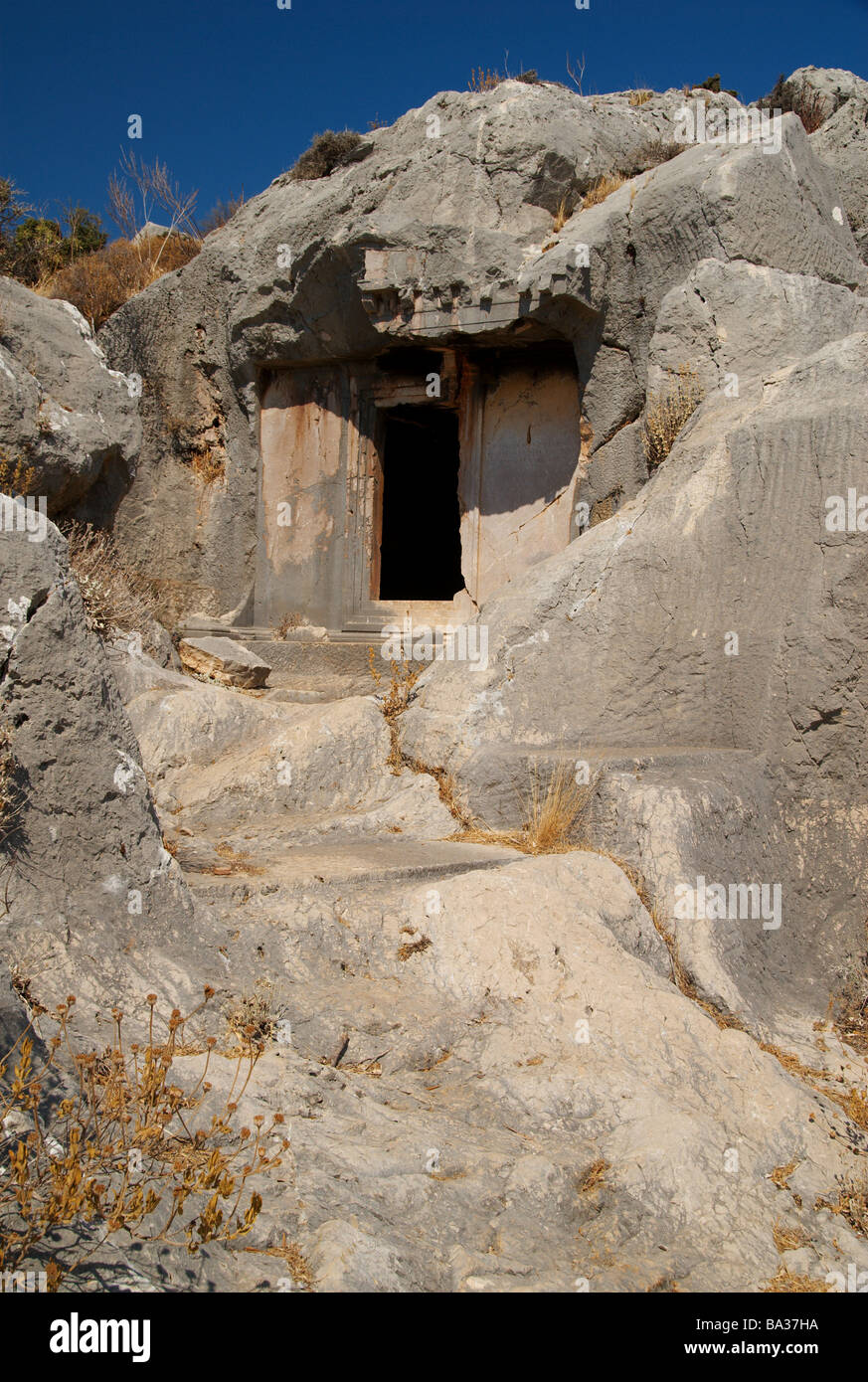An ancient Lycian tomb cut out of the side of a hillside Xanthos Turkey ...
