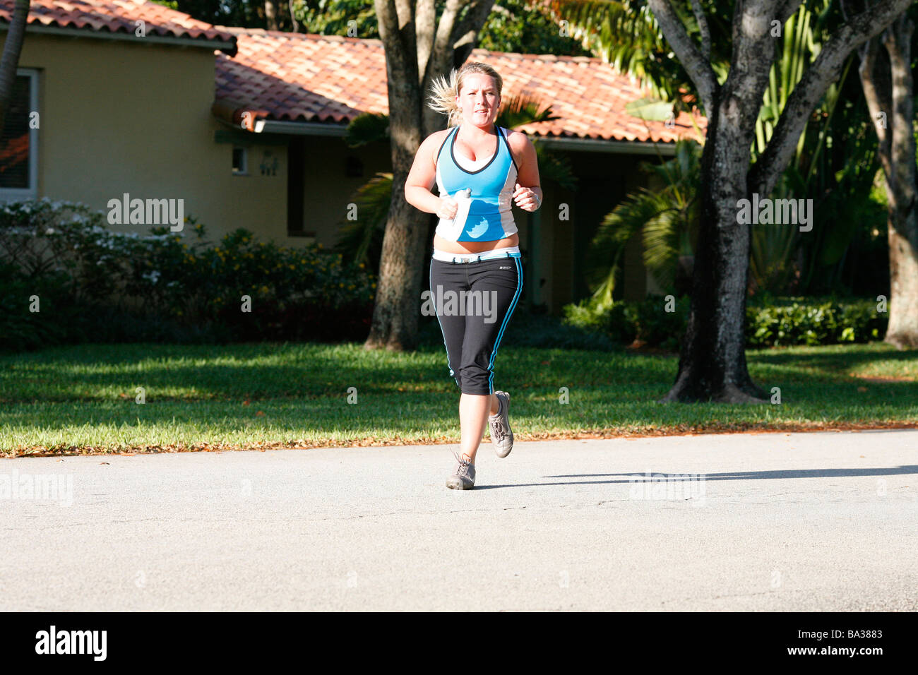 runner running through neighborhood Stock Photo - Alamy